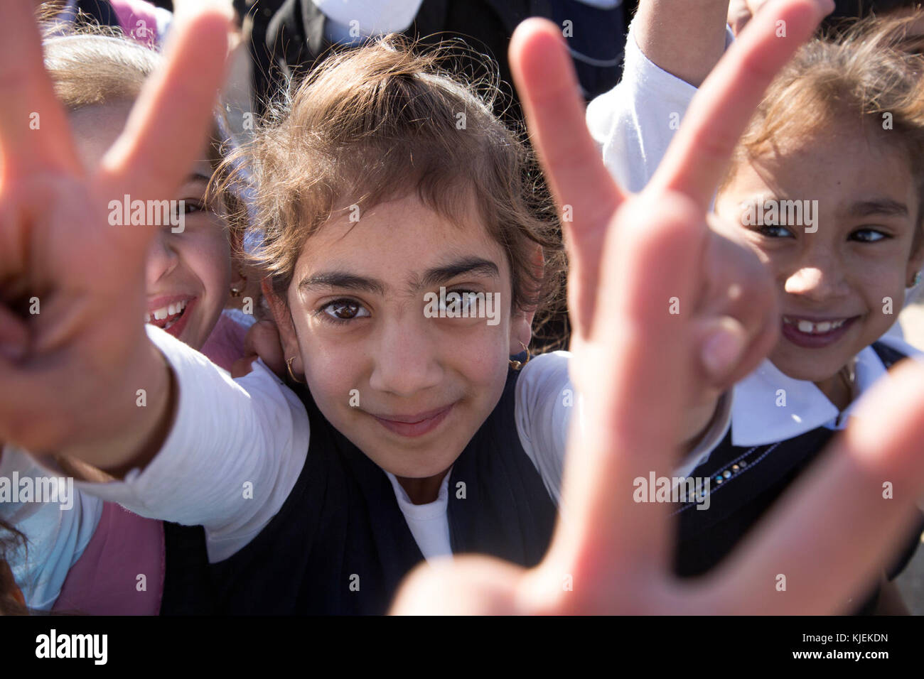 Iraqi students pose for a photo at a primary school in the Village of ...