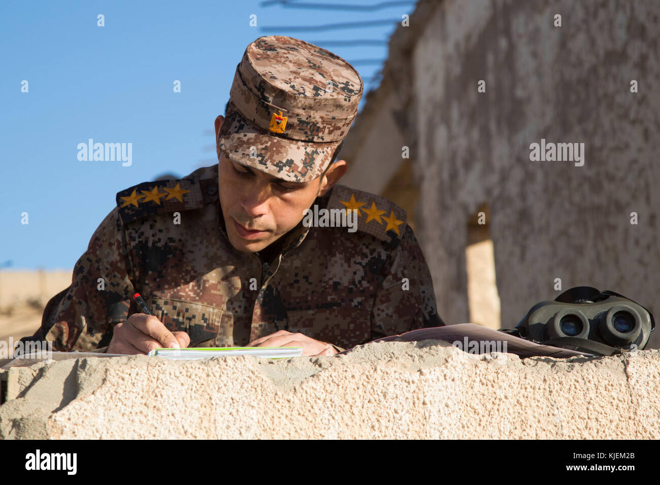 An Iraqi soldier plots coordinates on a map before calling in air ...
