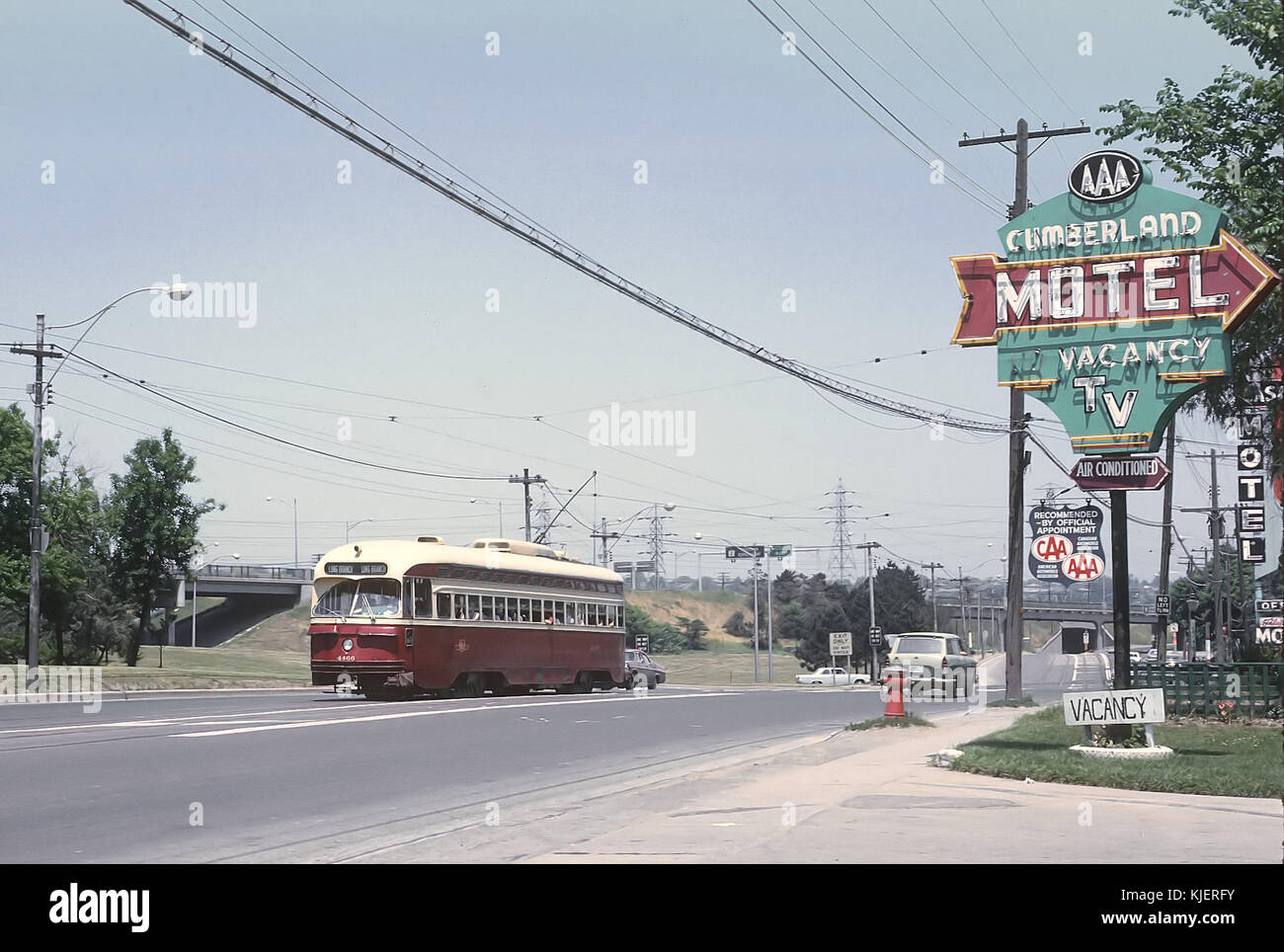 A photo of the TTC 4466 (PCC) streetcar, a Long Branch car, passing the Cumberland Motel in ...