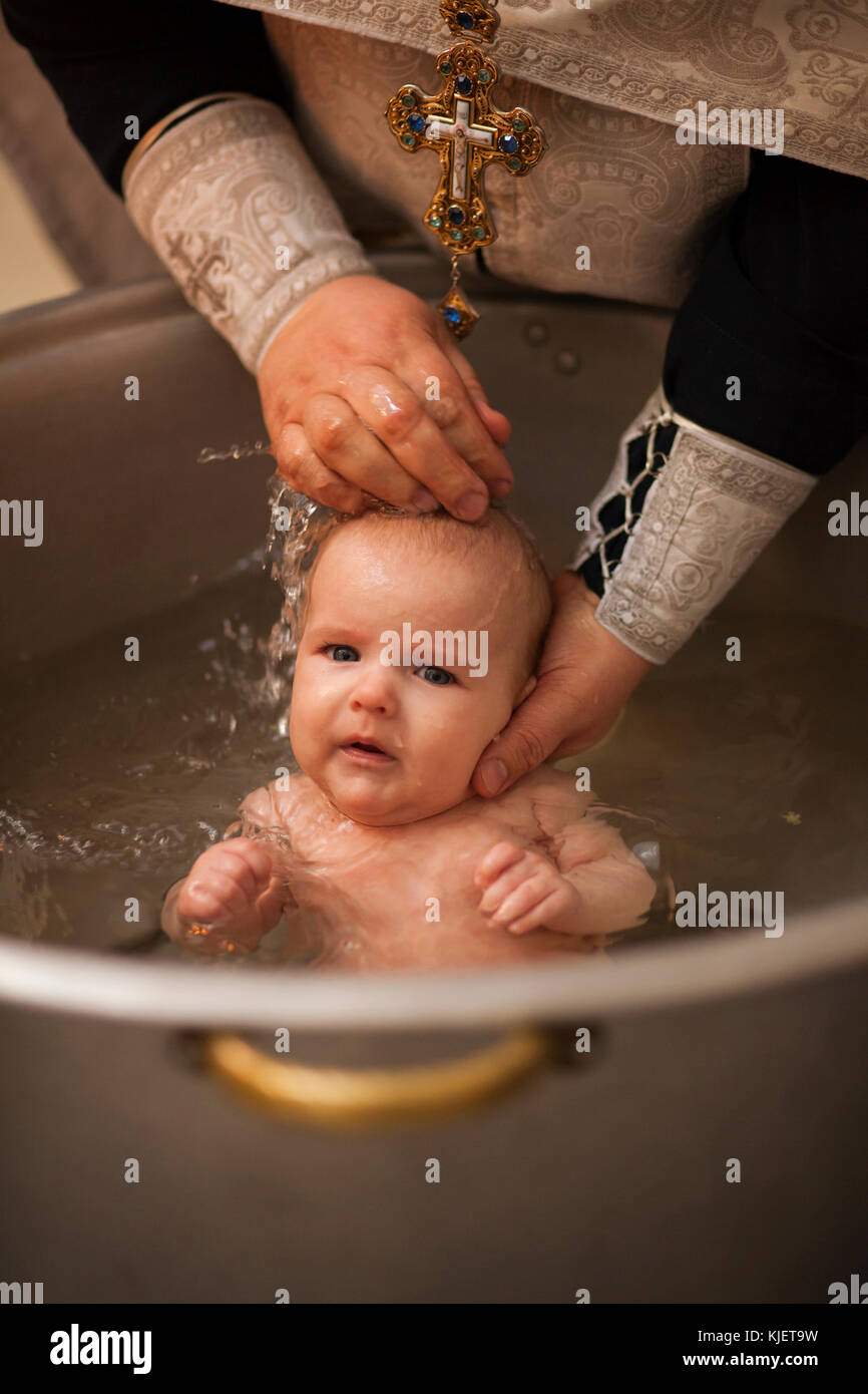Child being baptized hi-res stock photography and images - Alamy