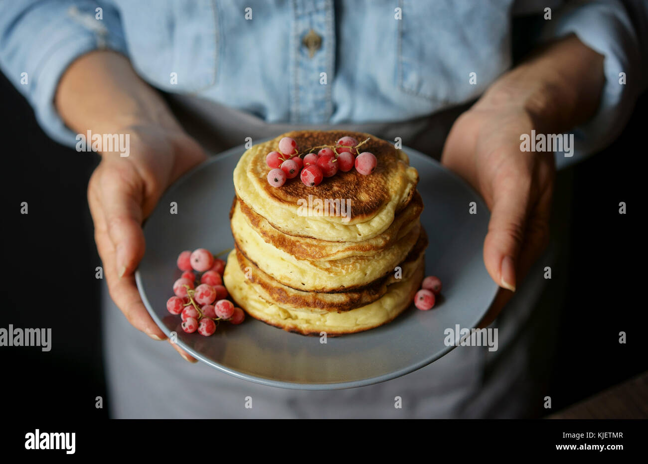 Close up of Caucasian woman holding plate of pancakes Stock Photo - Alamy