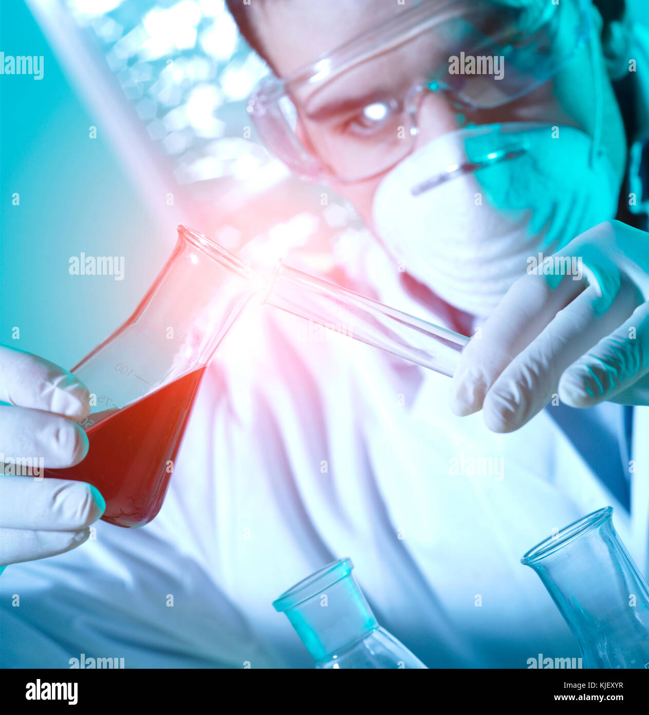 Caucasian scientist pouring red liquid into test tube Stock Photo - Alamy