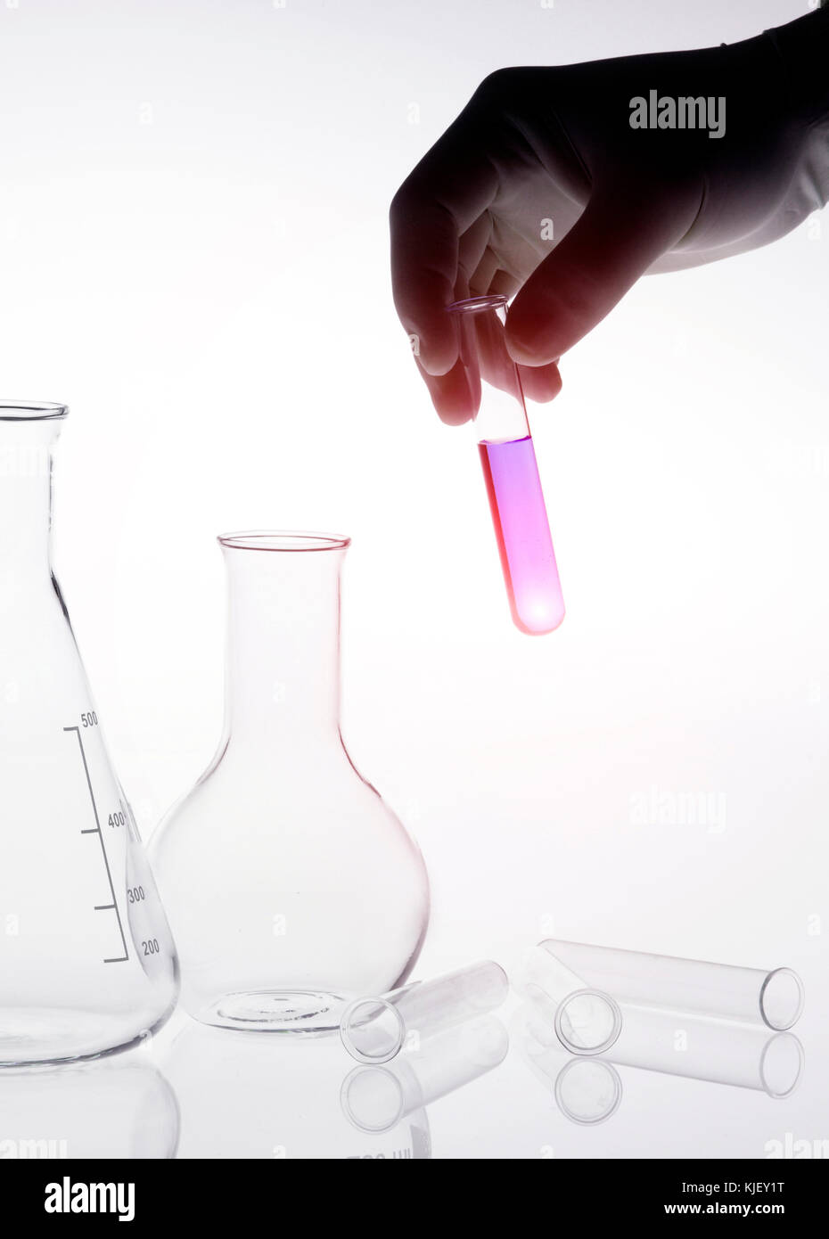 Caucasian scientist holding purple liquid in test tube Stock Photo - Alamy