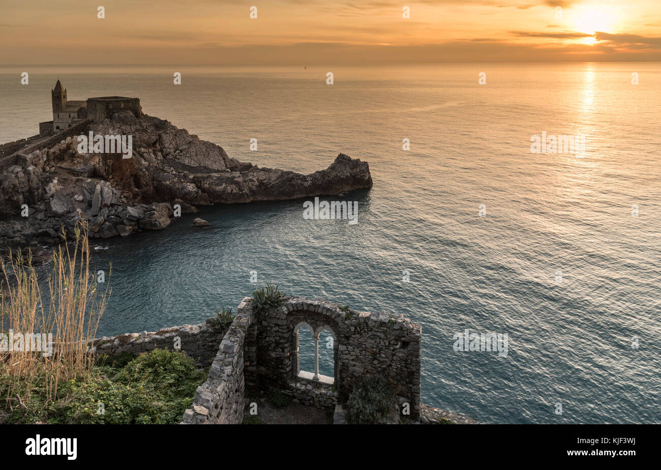 Stone building near ocean at sunset Stock Photo - Alamy