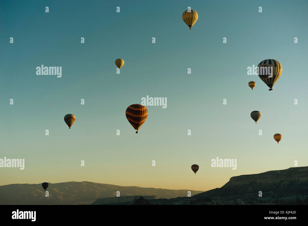 Hot air balloons flying at sunset Stock Photo - Alamy