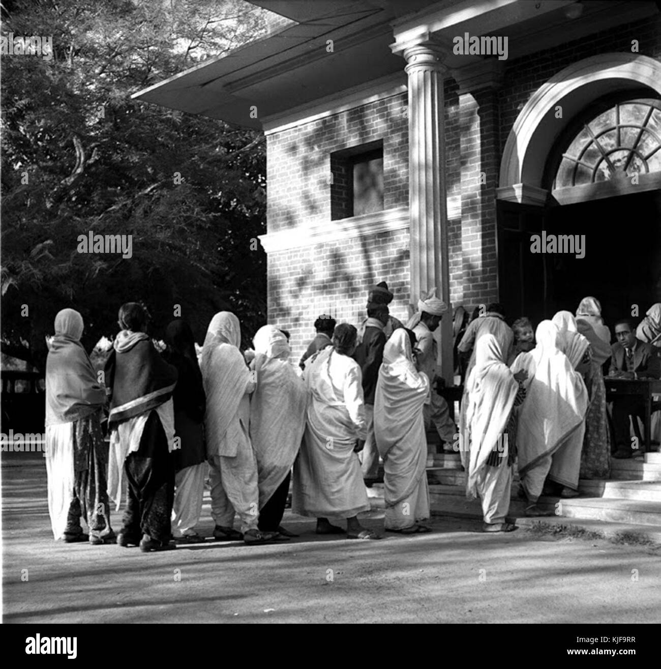A long queue of women voters are seen waiting for their turn to cast ...