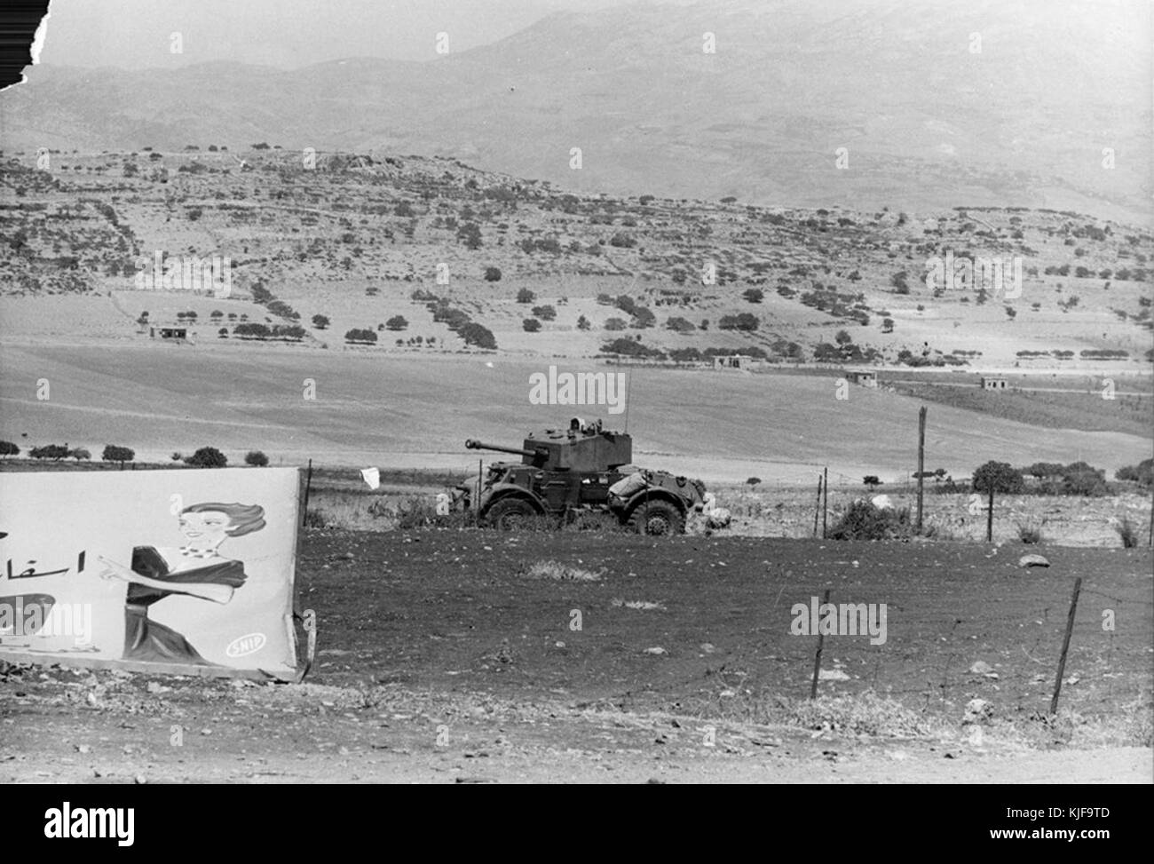 This image captures a military tank advancing in Iraq, depicting the ...
