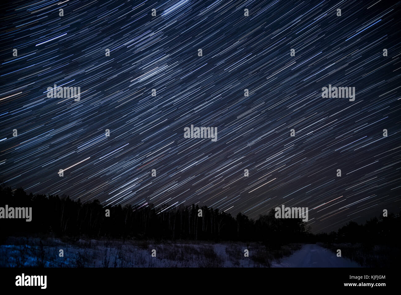 Night landscape with traces of the stars in the night sky on background ...