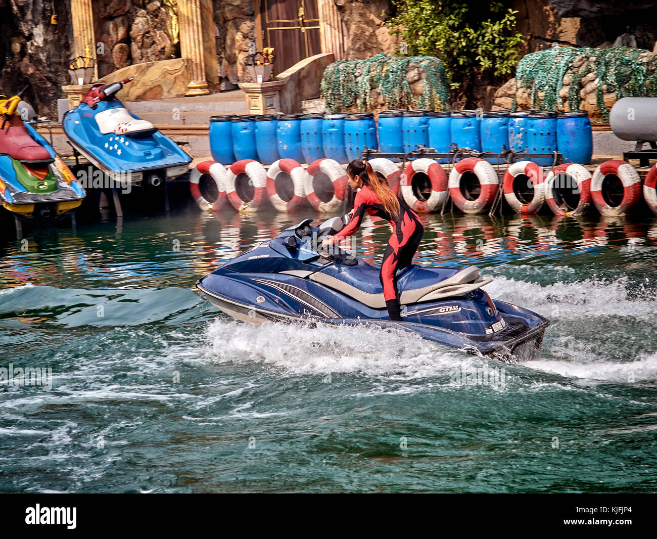 Jet ski stunt rider action with a female stunt rider Stock Photo - Alamy