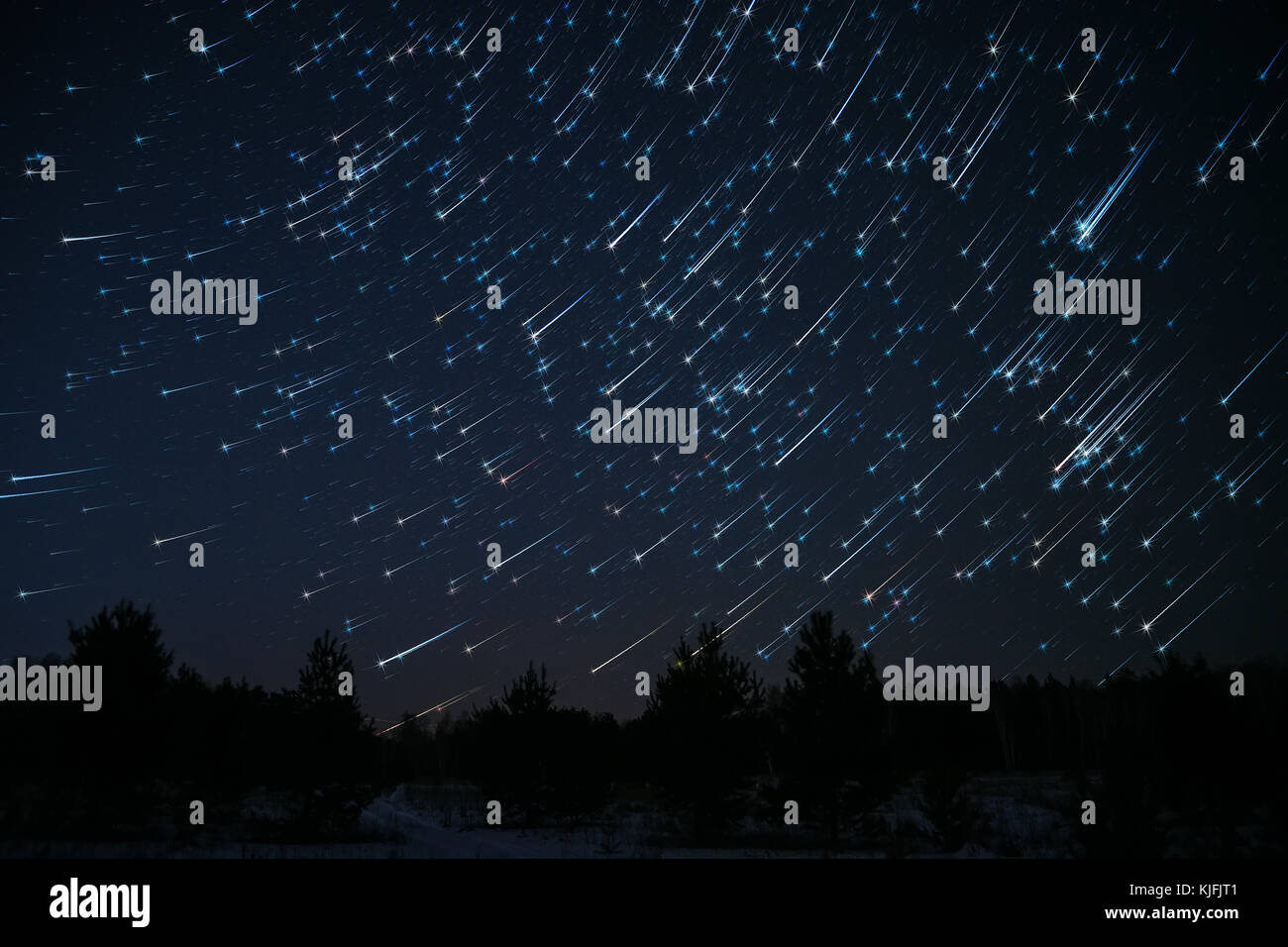 Night landscape with stars and traces of the stars in the night sky on ...