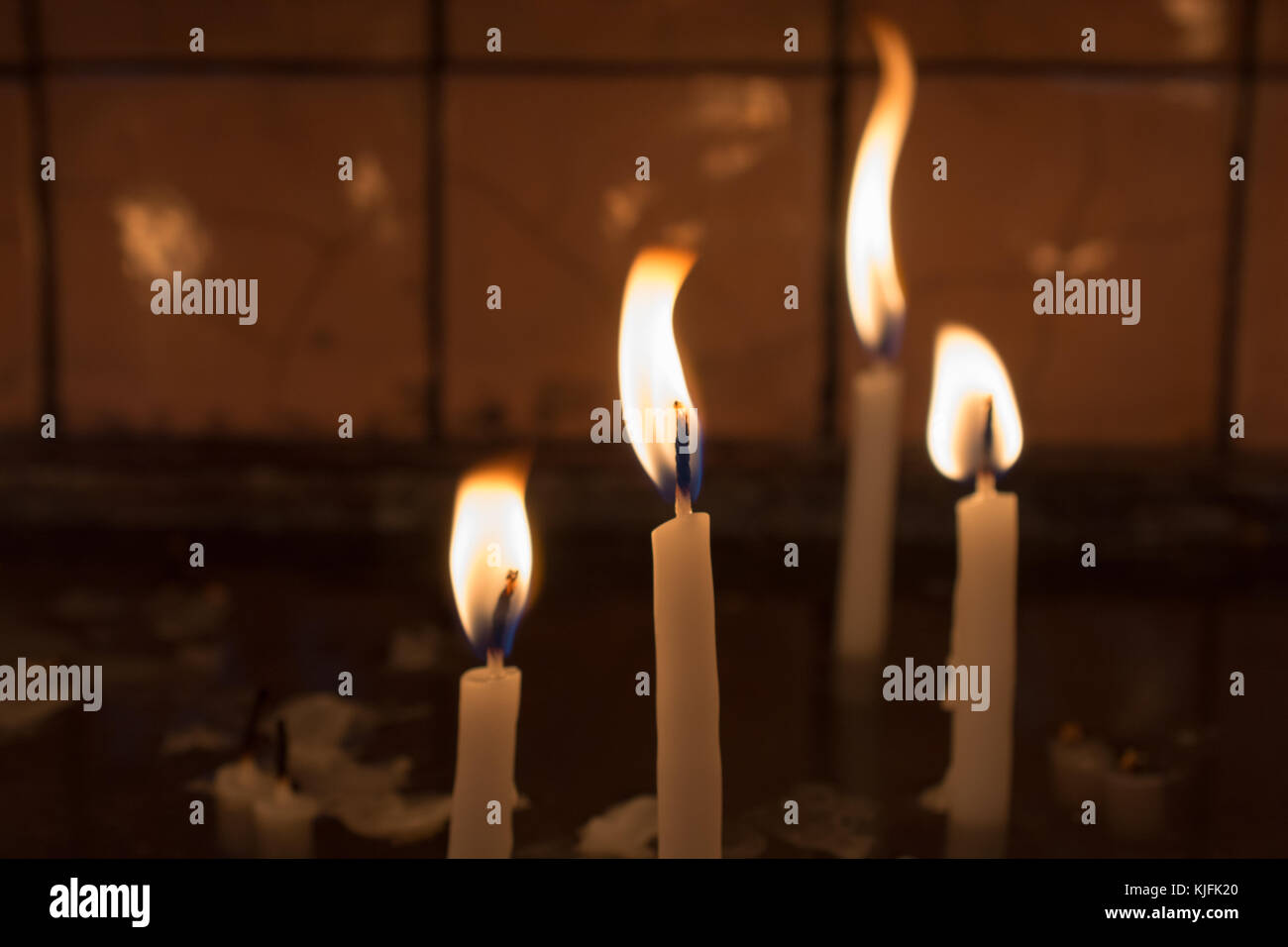 Burning candles with candle light in the dark Stock Photo - Alamy
