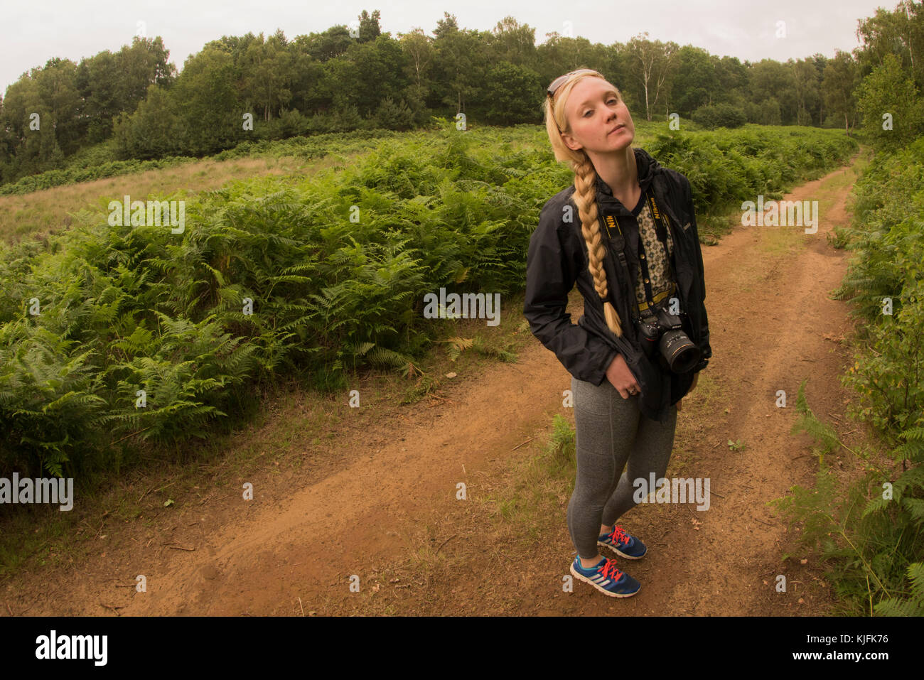 A female photographer with her camera enjoying the british countryside ...