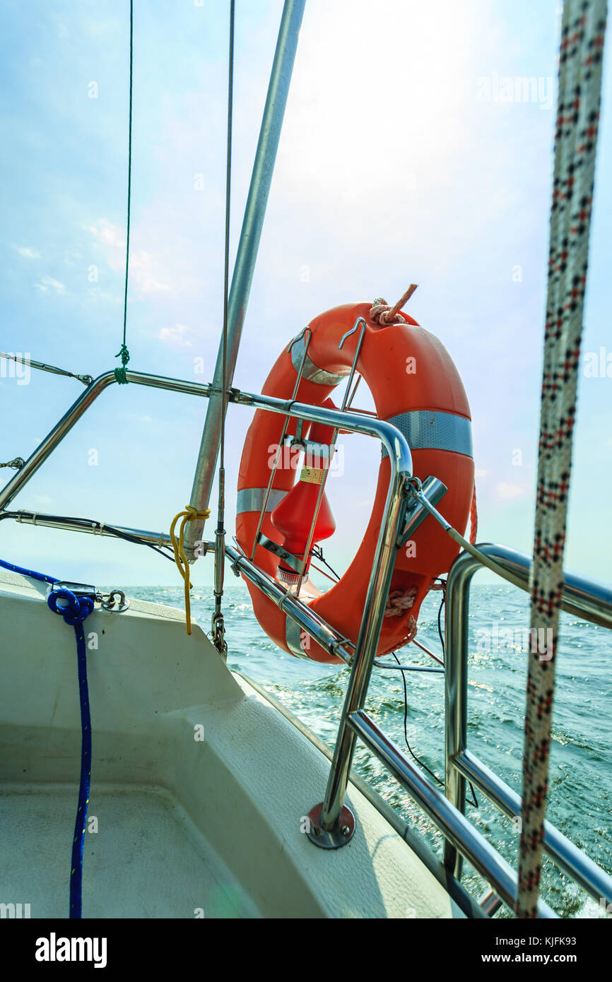 Rescue red lifebuoy life preserver saver ring on sailboat. Yachting in ...