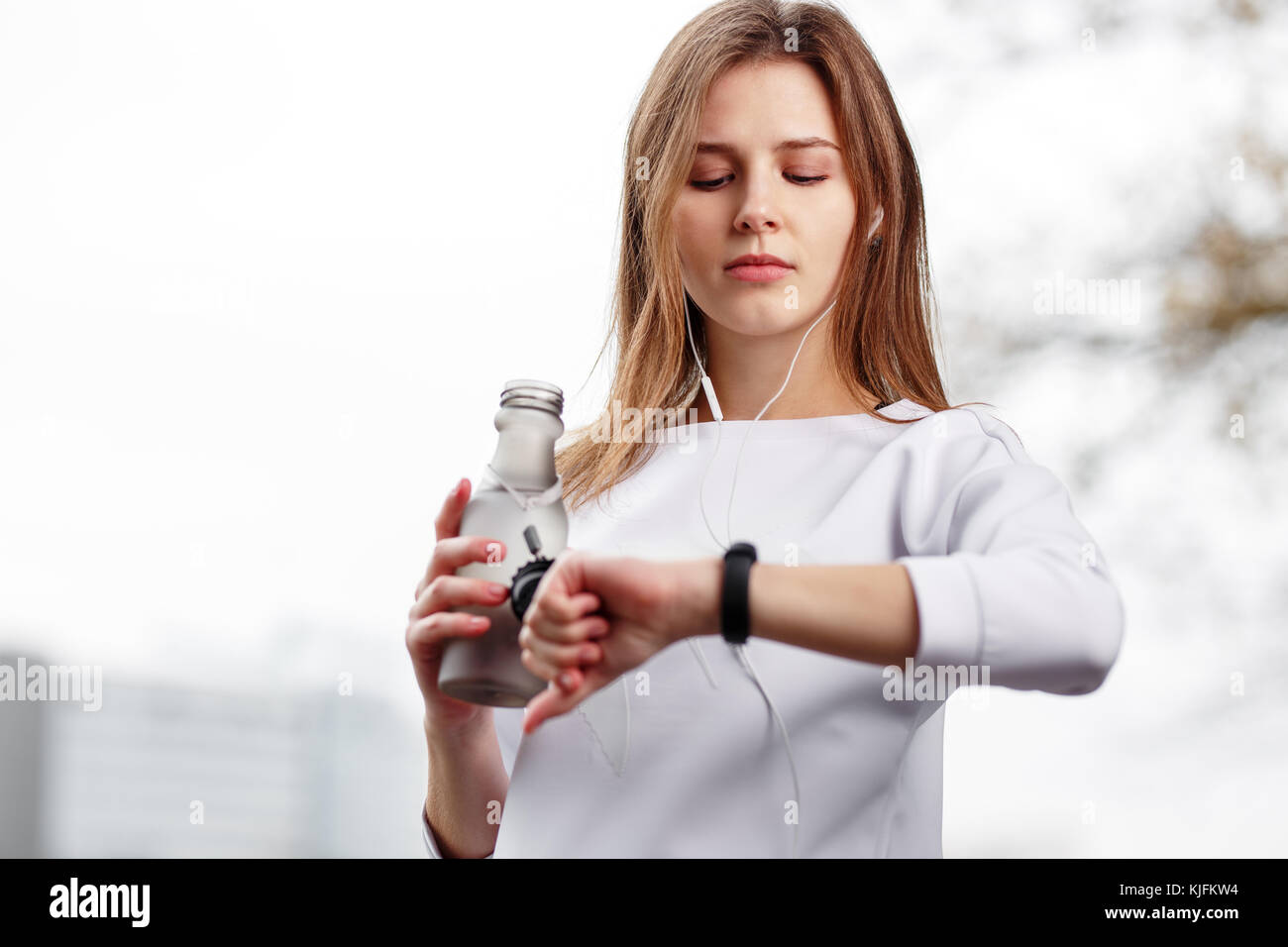 Woman checking fitness and health tracking wearable device Stock Photo ...