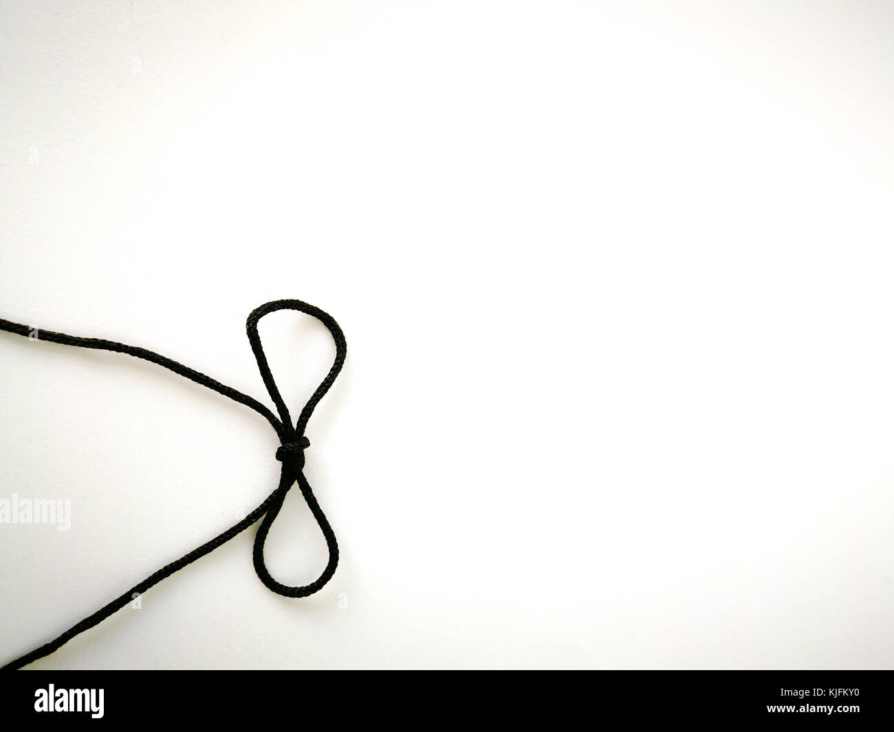 Rope bow black color on white isolated background Stock Photo - Alamy