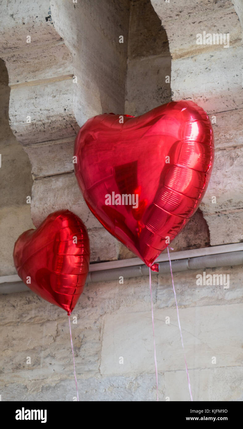 Little pink color heart shape balloon in air Stock Photo - Alamy