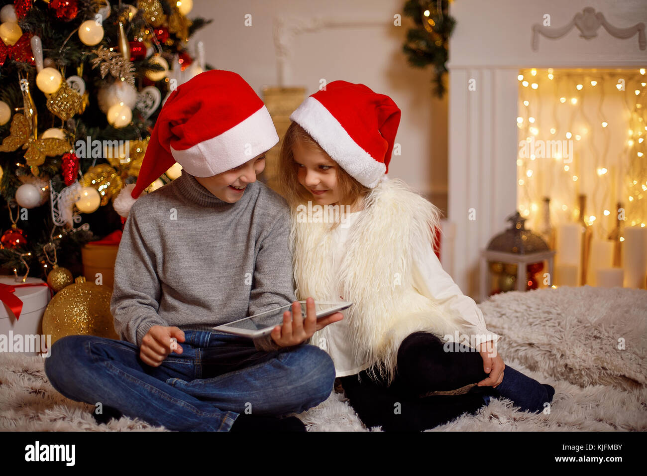 Excited children near Christmas tree Stock Photo - Alamy
