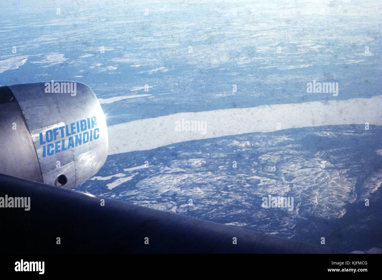 View out the window of an Icelandic Airlines jet airplane flying over a ...