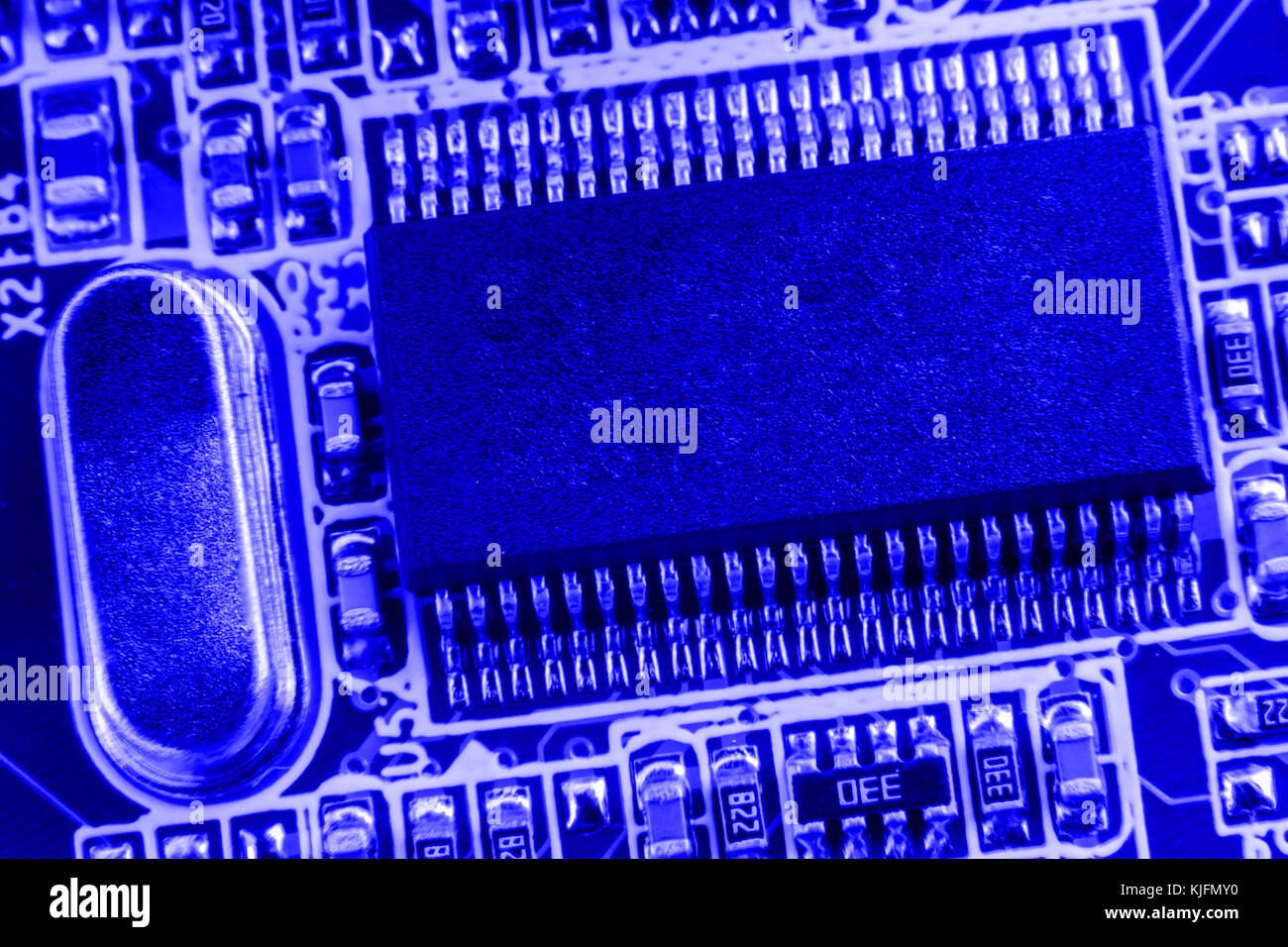 Microchip and quartz on the motherboard of a modern computer blue ...