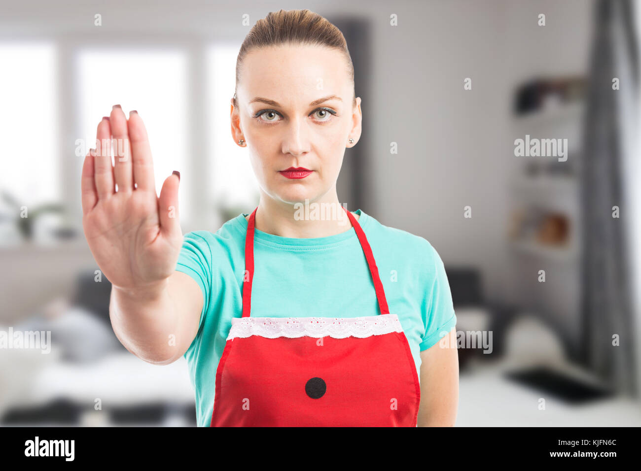 Private maid or housekeeper showing stop stay gesture using hand palm ...