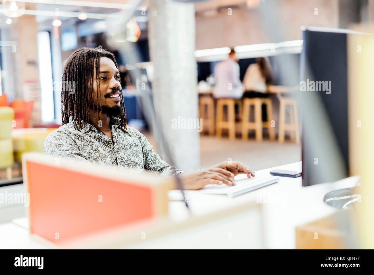 Black handsome designer doing his work on a computer Stock Photo - Alamy