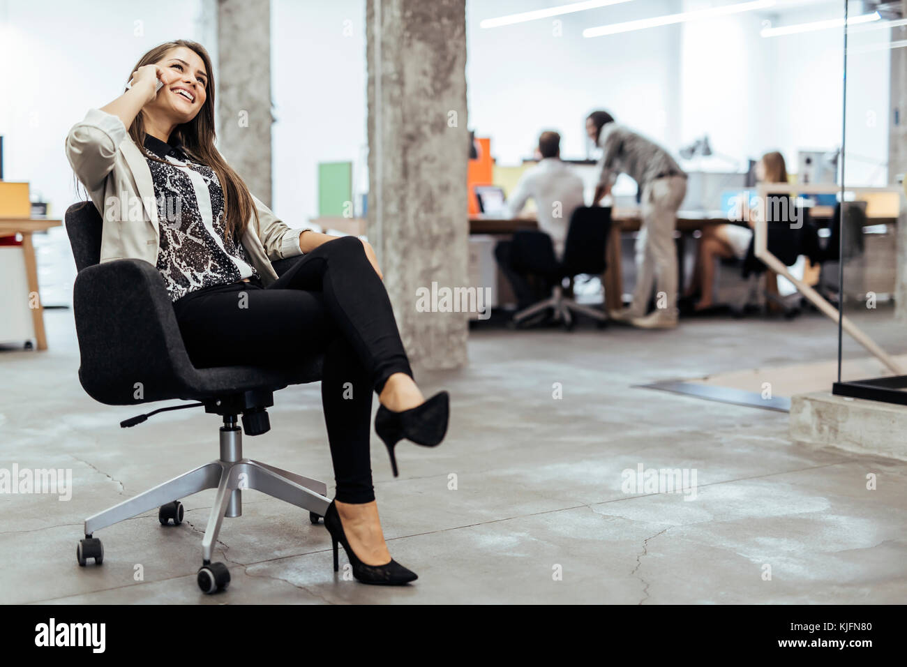 Confident business woman using phone Stock Photo - Alamy
