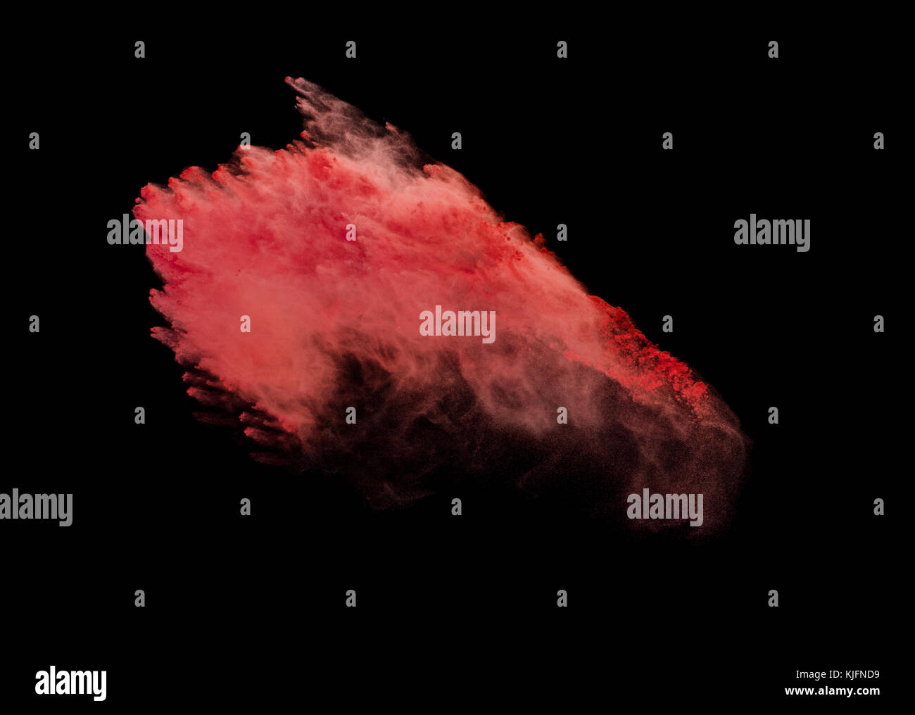 Explosion of red powder isolated on black background Stock Photo - Alamy