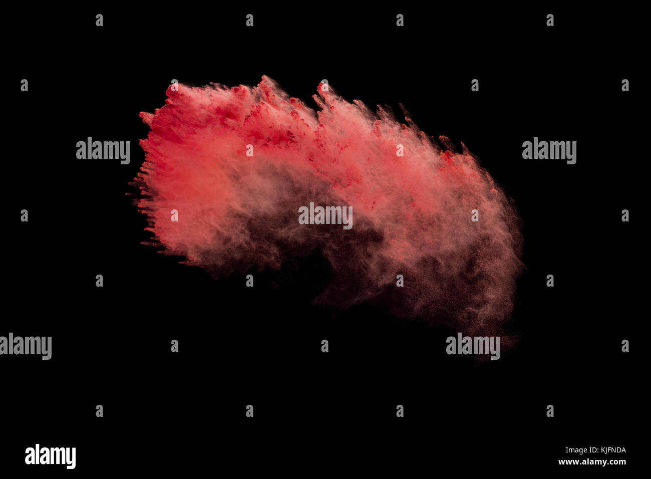 Explosion of red powder isolated on black background Stock Photo - Alamy