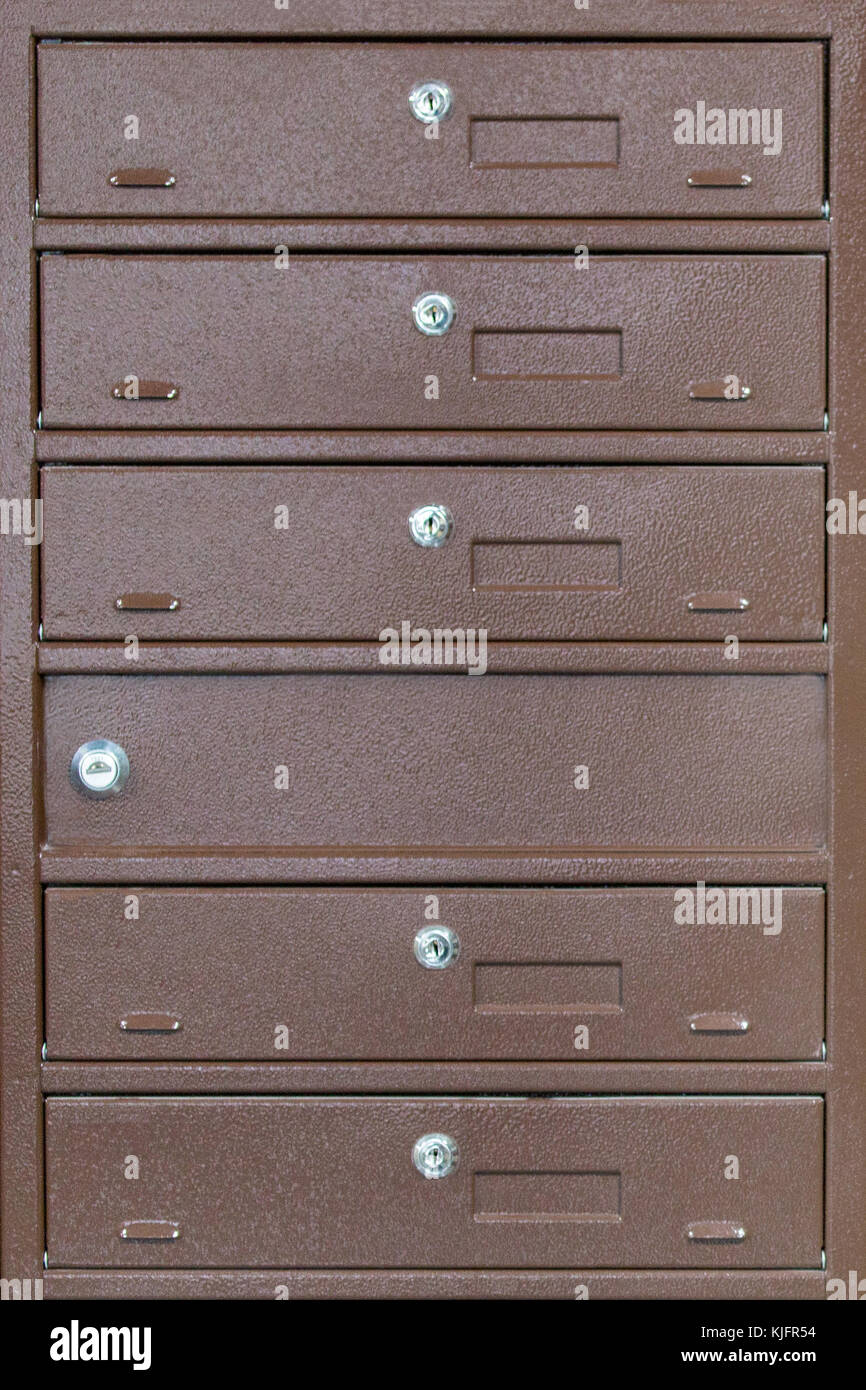 Multiple metal brown postbox in a lobby of apartments Stock Photo - Alamy