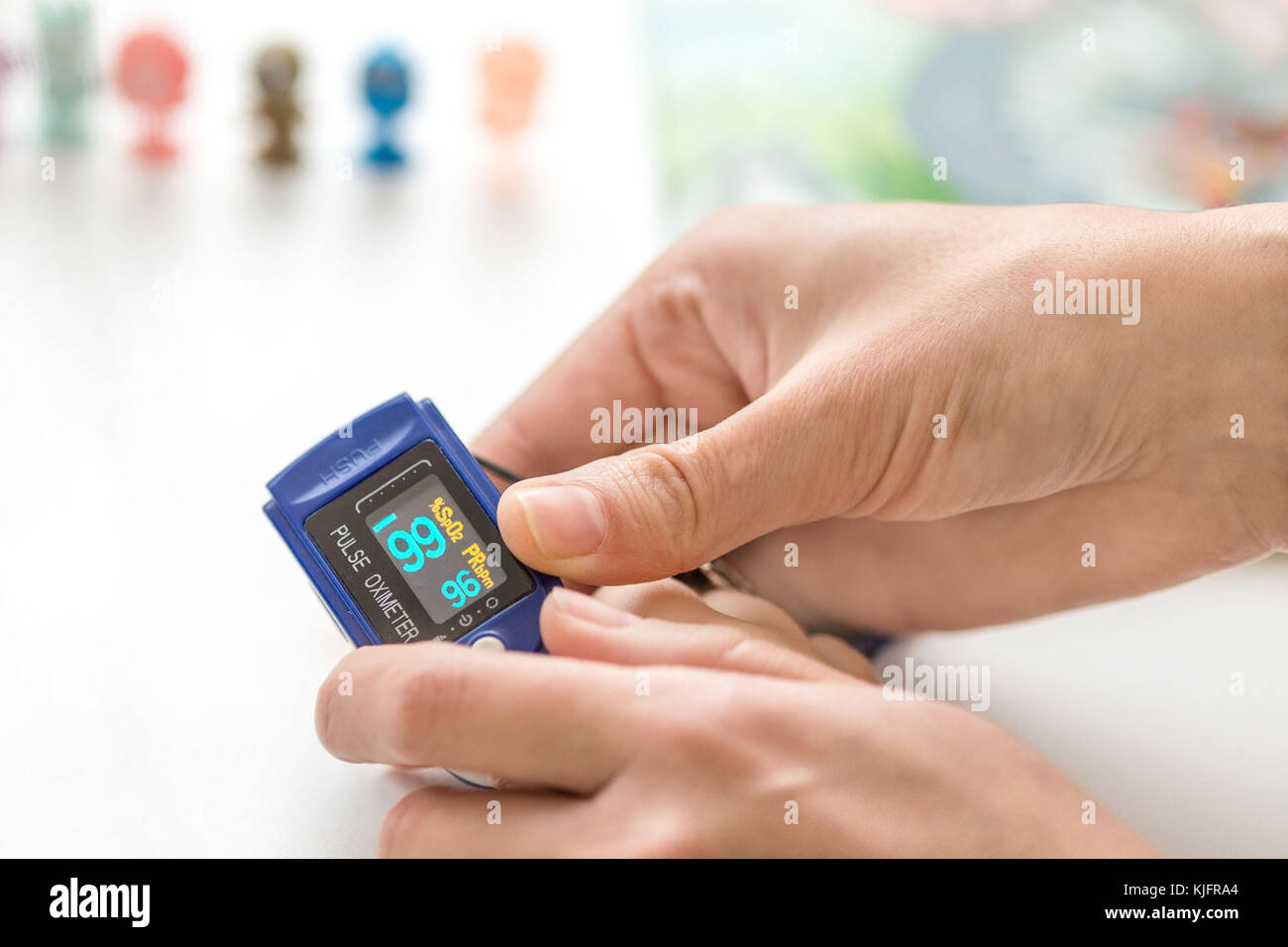 Doctor measuring kid's oxygen saturation level with finger oxymeter ...
