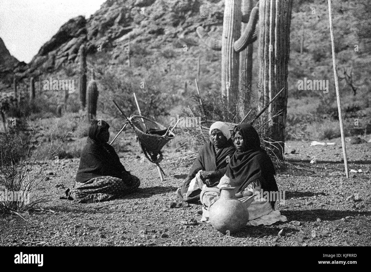 A photograph of three Native American women resting, they are all ...