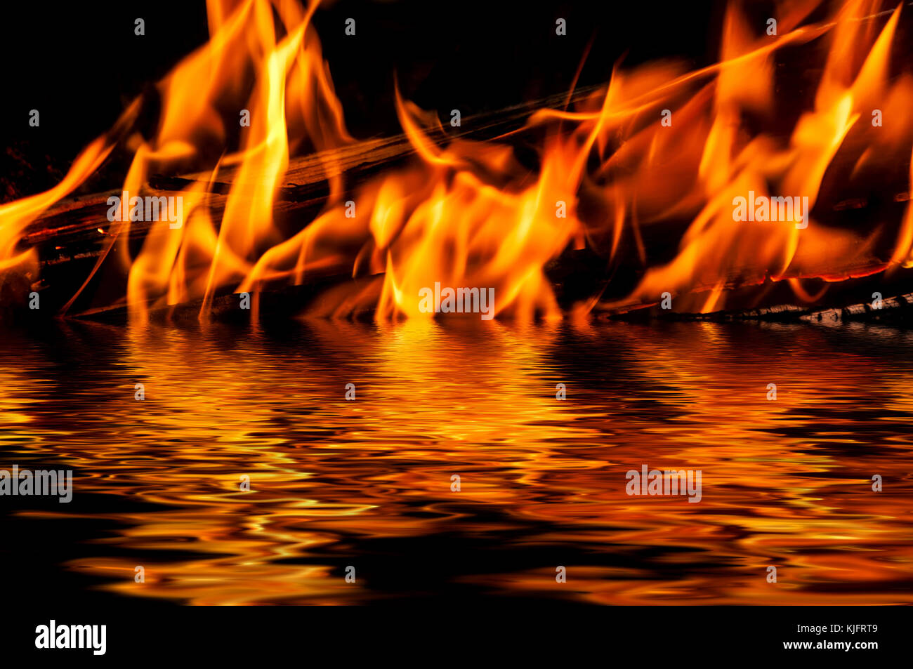 Flames of fire and sparks on a black background with reflection in ...