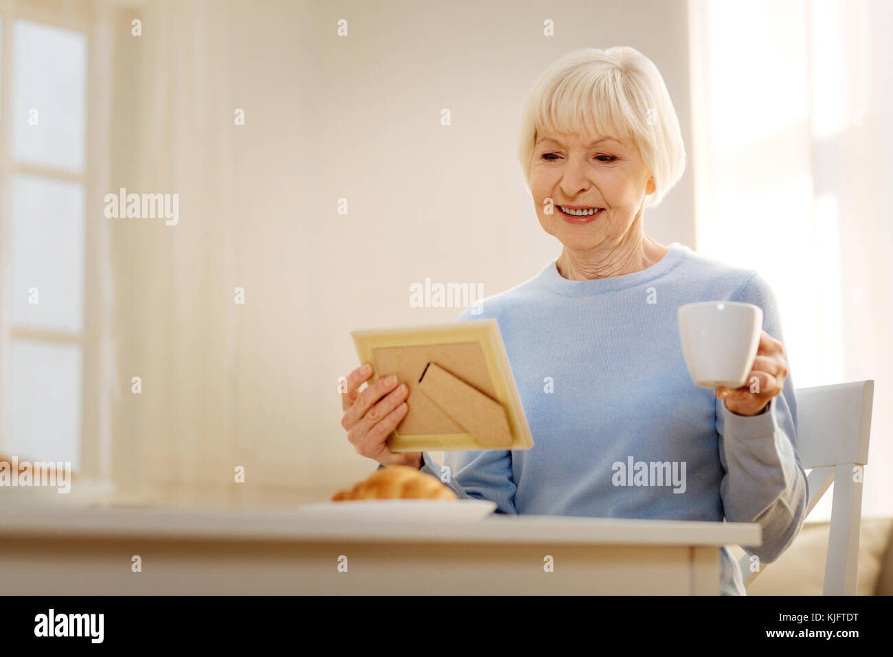 Charming female having morning tea Stock Photo - Alamy