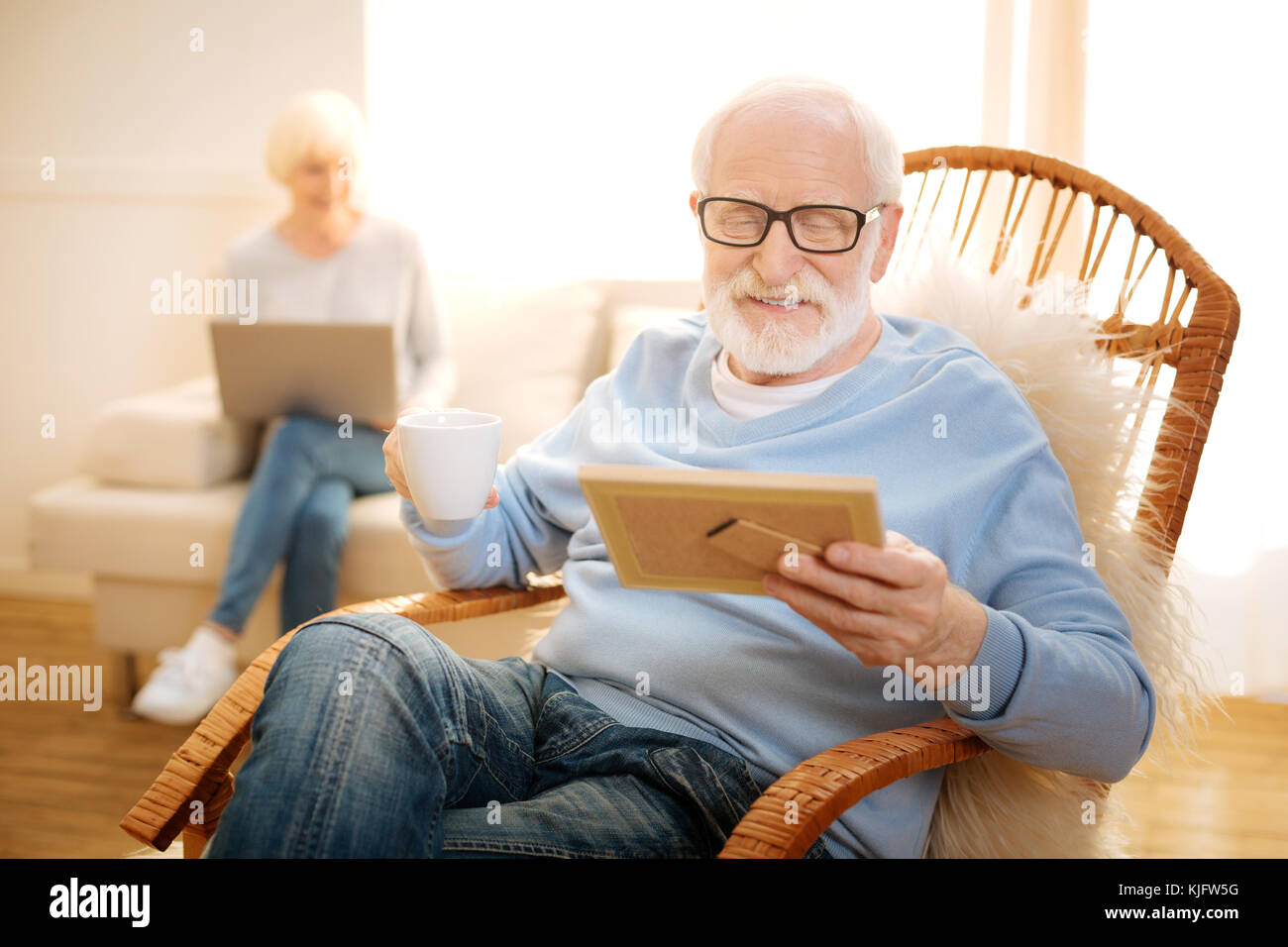 Positive delighted male person staring at photo Stock Photo - Alamy