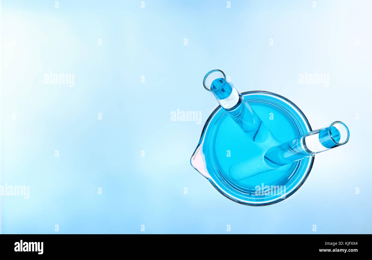 Chemical laboratory glassware with beaker and flasks filled with ...