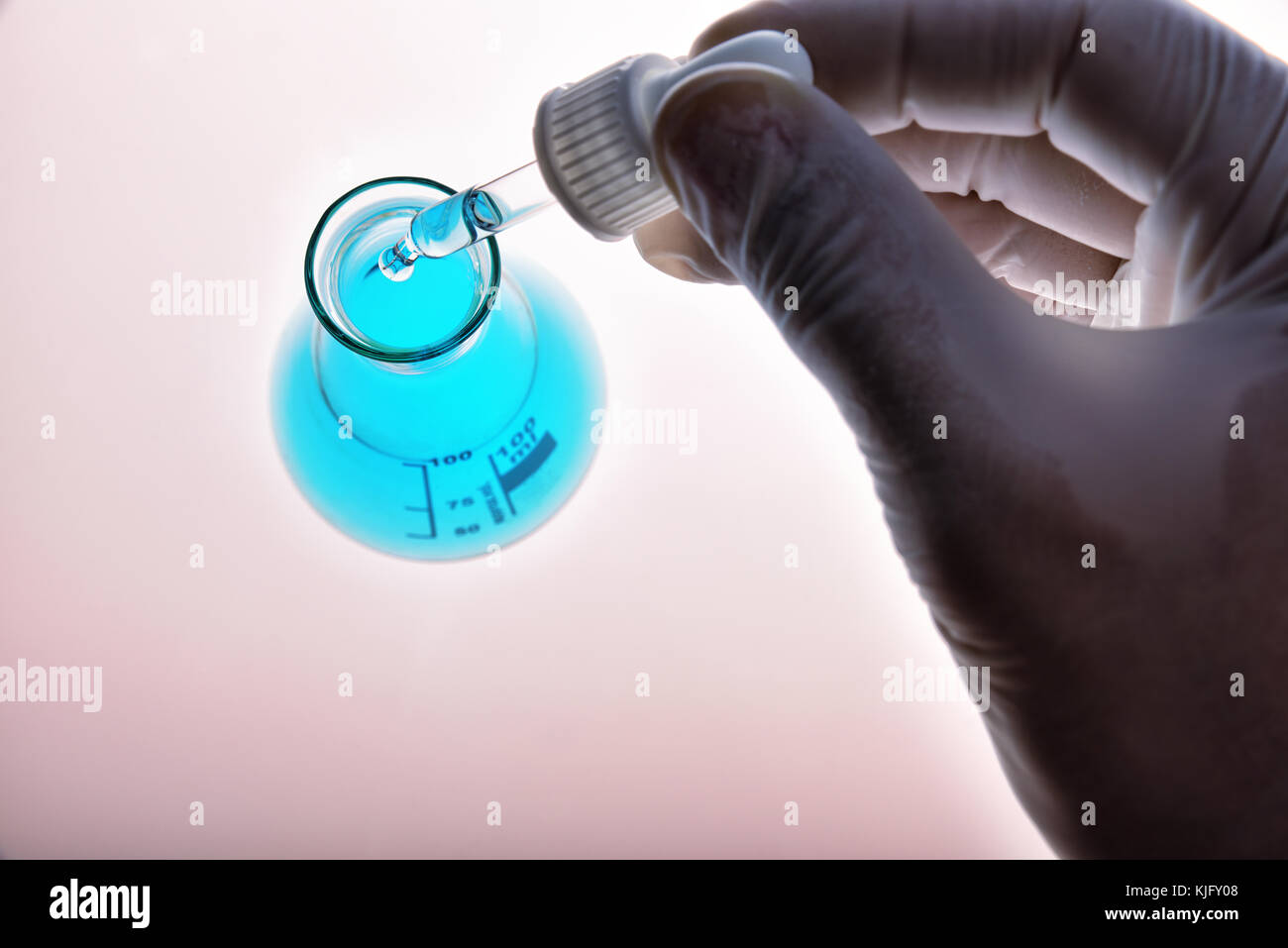 Laboratory worker hand with dropper and glass chemical containers on ...