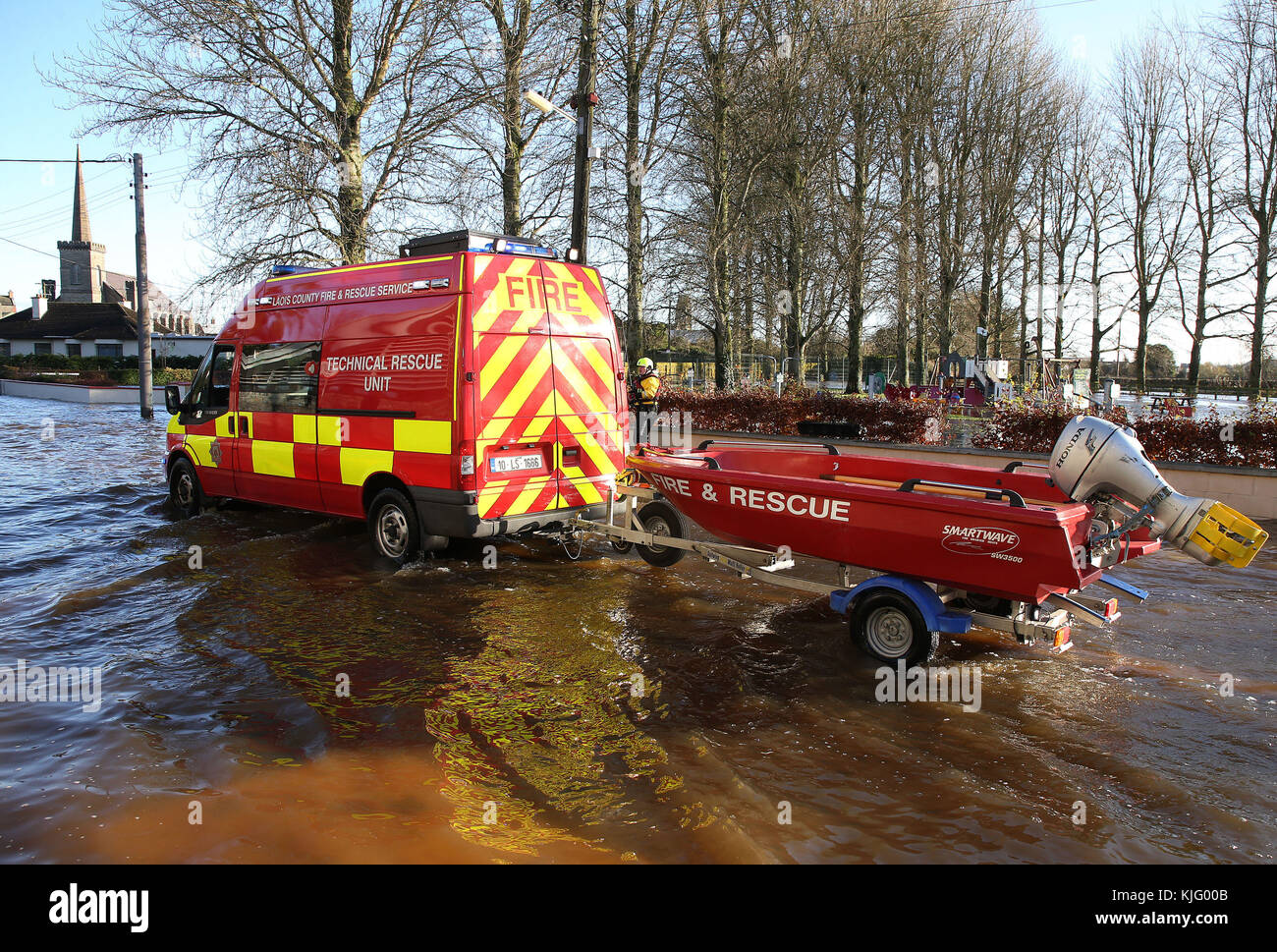 A technical rescue unit of the fire service drives through flood water ...