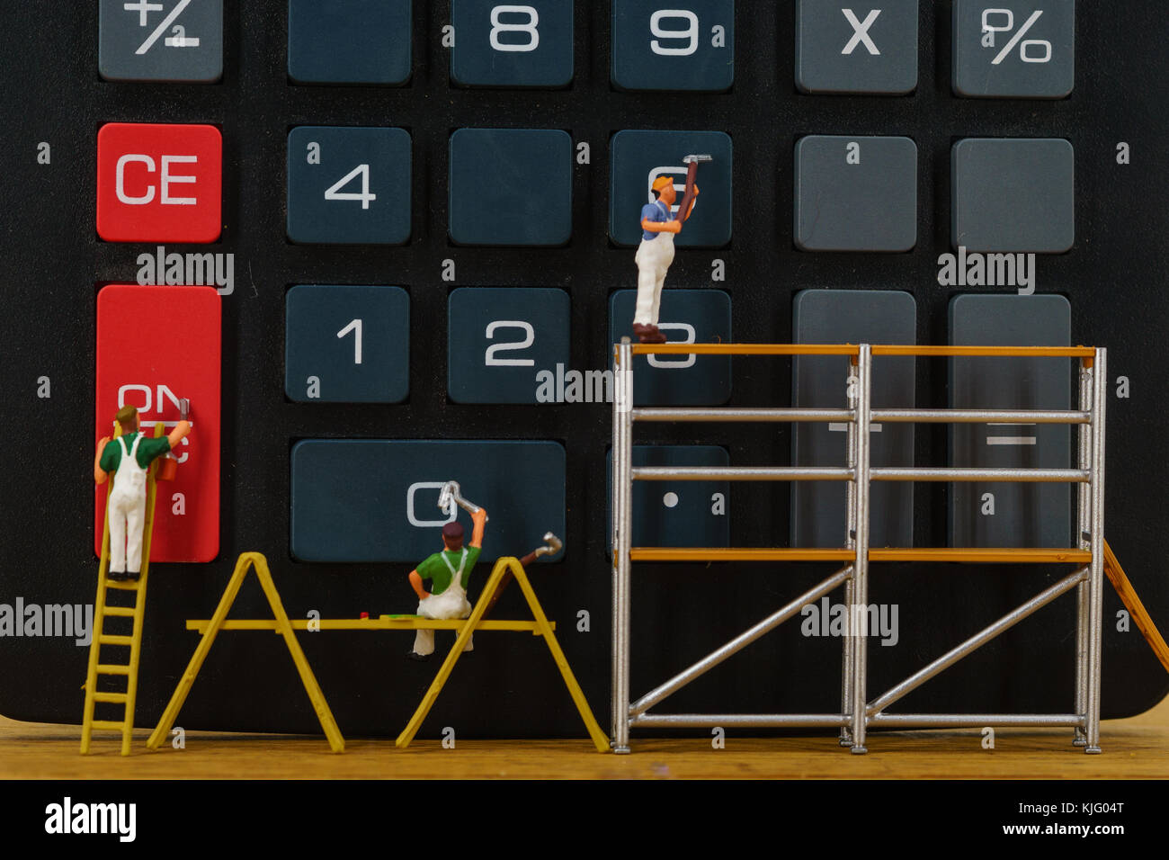 Miniature people worker figures painting calculator grey and red Stock ...