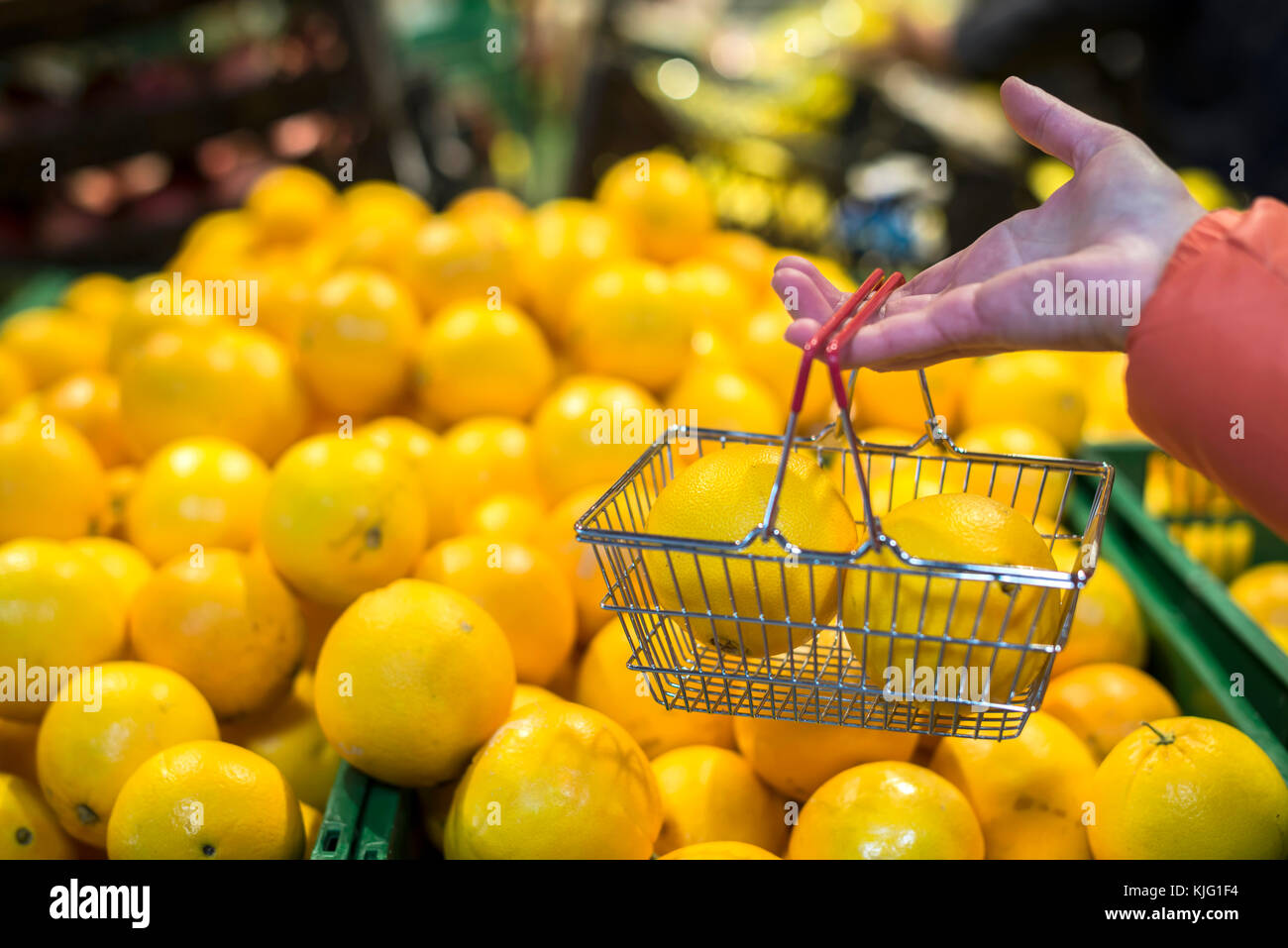 Fruits in supermarket. Buying oranges in shop. Small basket Stock Photo ...