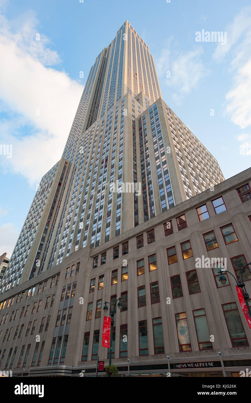 Empire State building low vertical view against blue sky Stock Photo ...