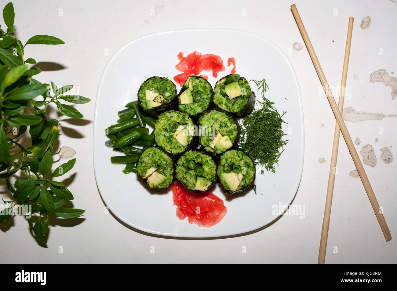 Fresh raw food dish. Green rolls of grape leaves stuffed with chopped ...