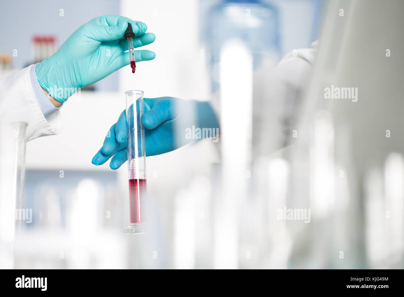 Close-up of two lab technicians pipetting Stock Photo - Alamy
