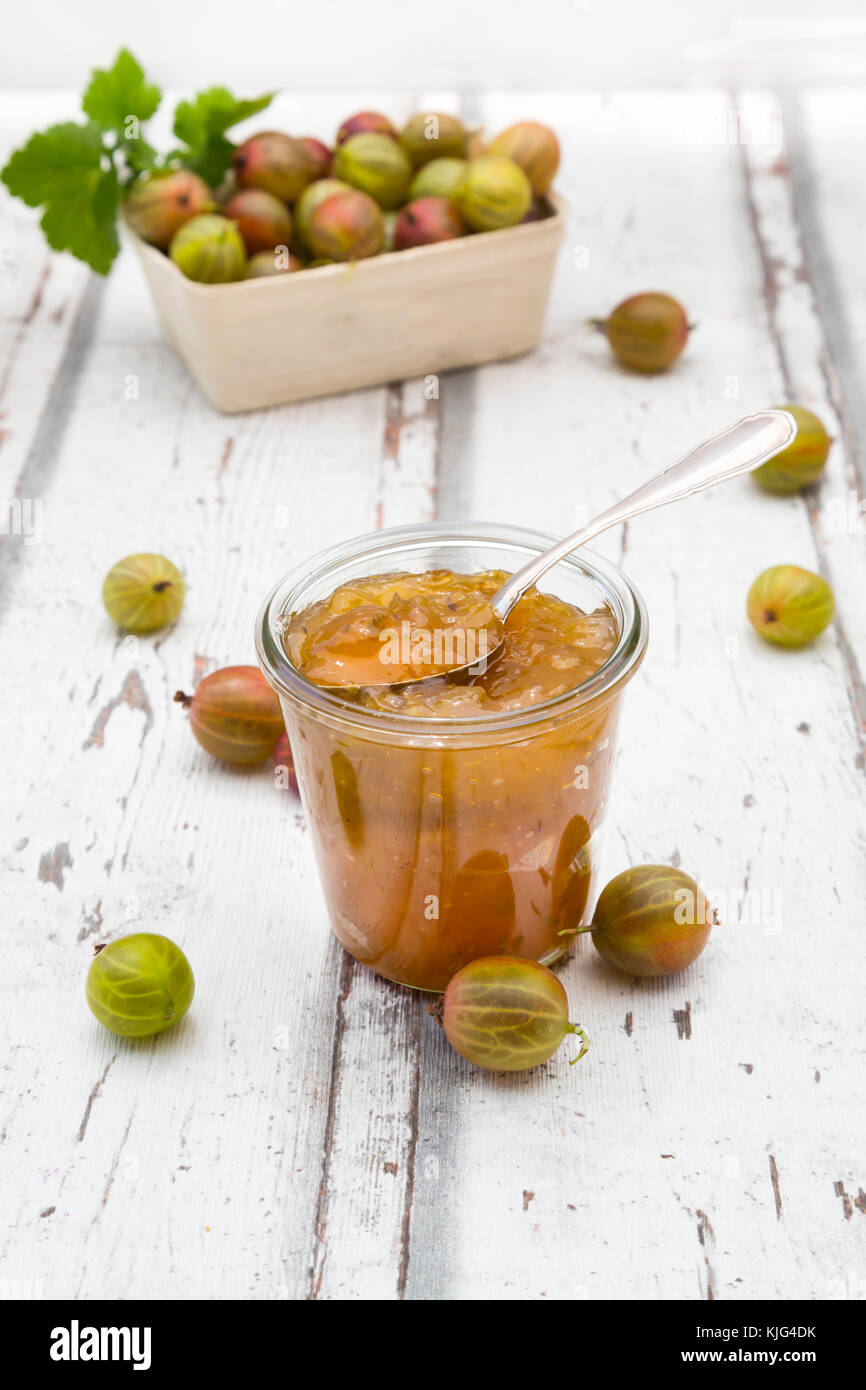 Jar of gooseberry jam and gooseberries on wood Stock Photo - Alamy