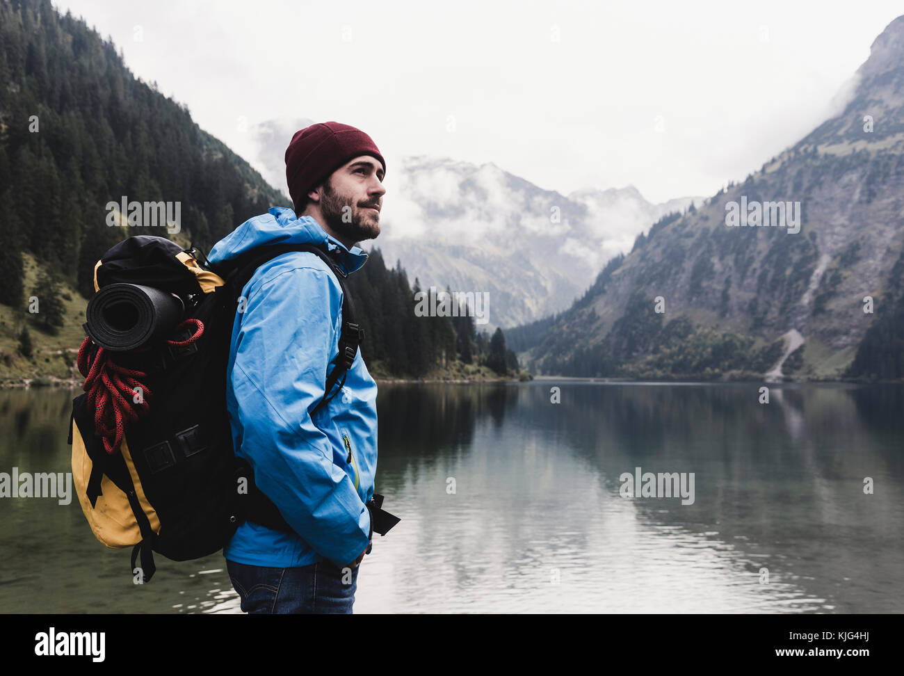 Austria, Tyrol, Alps, hiker standing at mountain lake Stock Photo - Alamy
