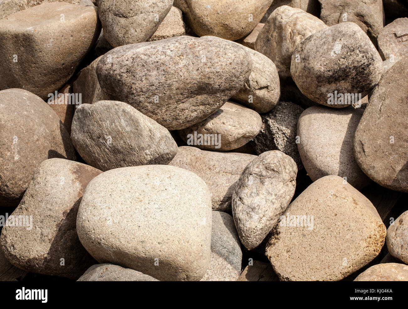 A pile of beige stone in a shore of a beach Stock Photo - Alamy