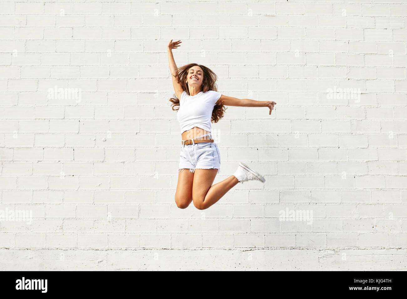 Full length celebrating jumping in air hi-res stock photography and ...
