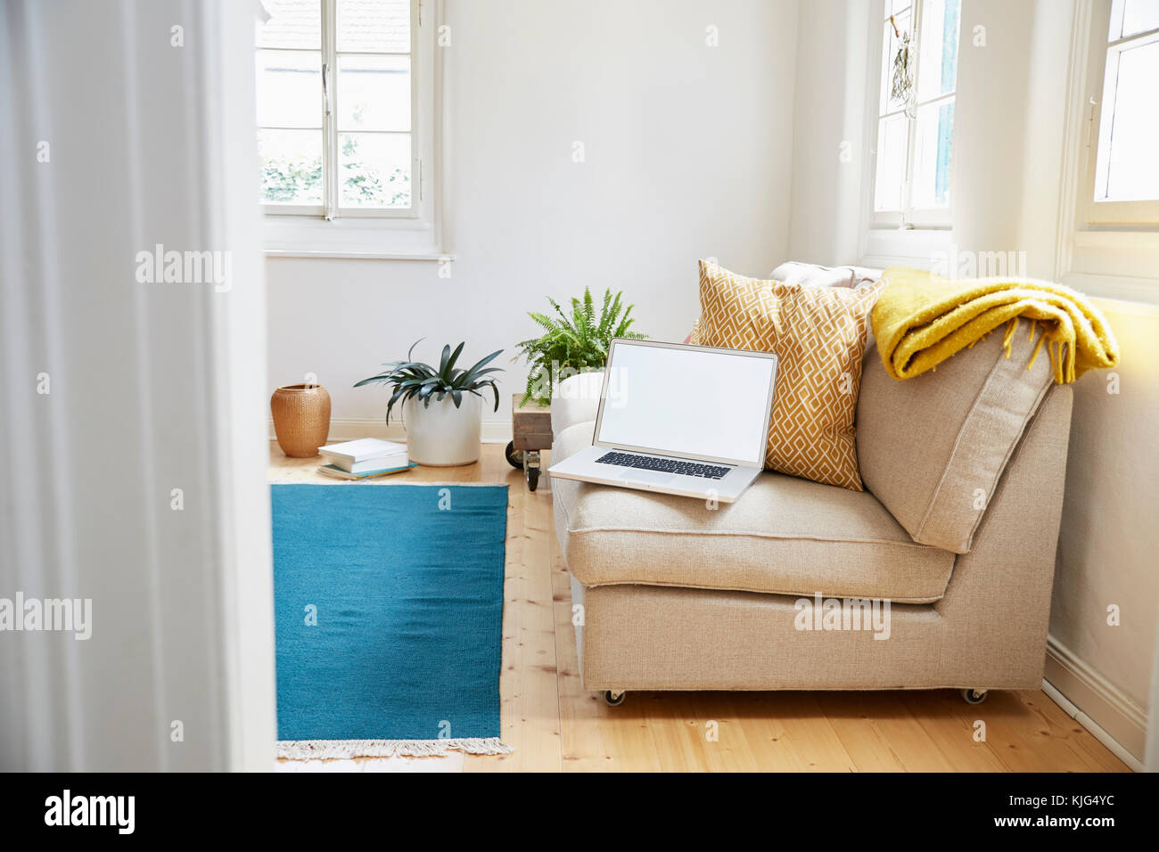 Laptop on couch in a modern living room of an old country house Stock ...