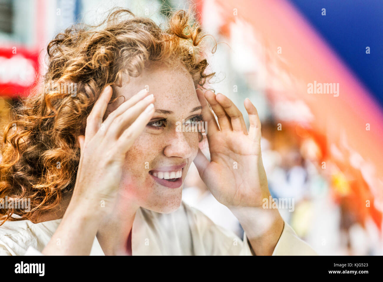 Young woman looking in shop window Stock Photo - Alamy