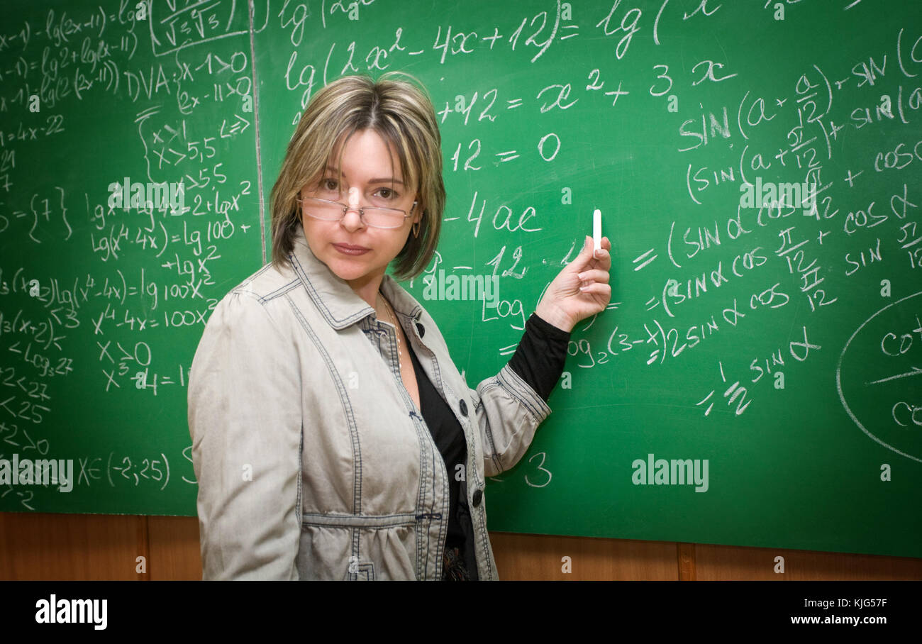 Teacher at school in the classroom ready for work Stock Photo - Alamy