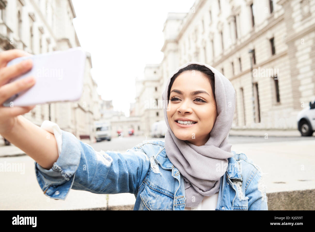London, UK, England, Young pretty muslim girl taking a self-portrait ...